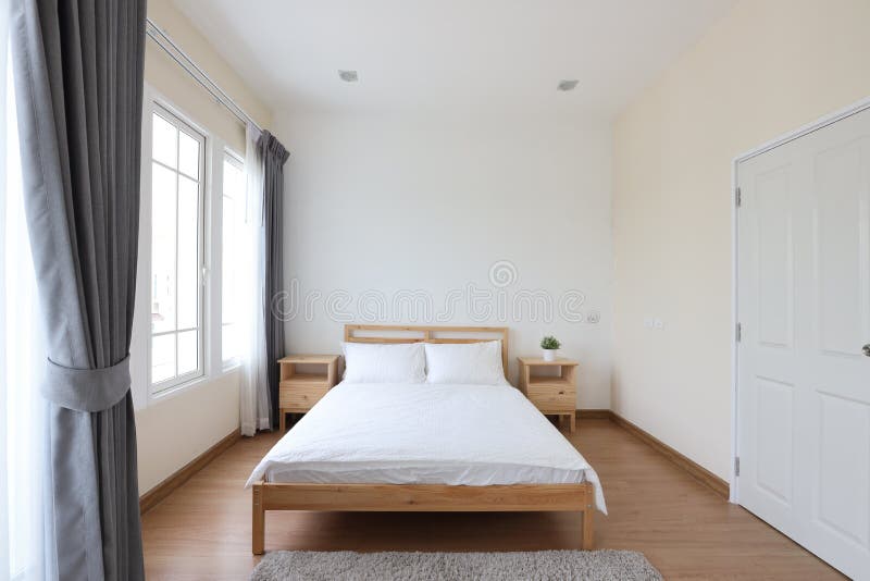 Front View of New Modern White Wooden Bed in White Bedroom with Soft ...