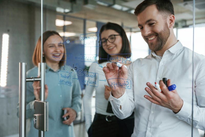 Front View. Office Workers are Creating Plan, Standing by Glass and ...