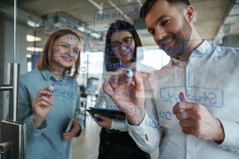 Front View. Office Workers are Creating Plan, Standing by Glass and ...