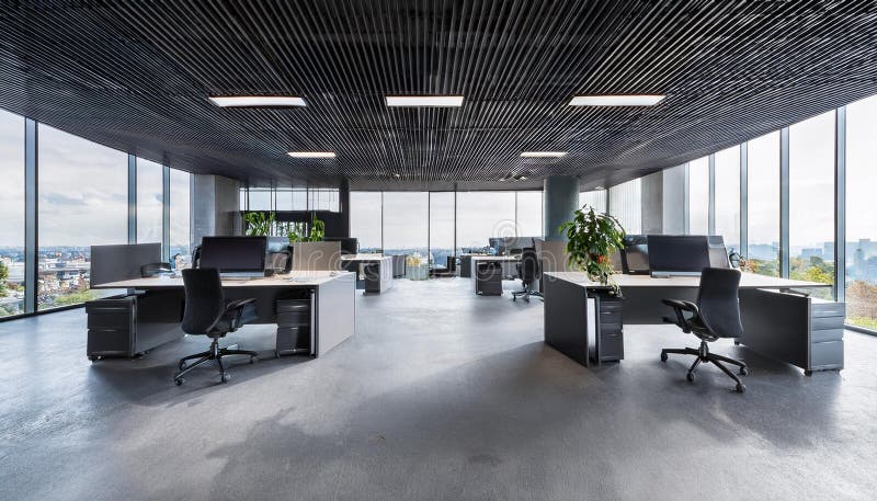 Front View of an Open Office Interior with Desks, Computers, a Concrete ...