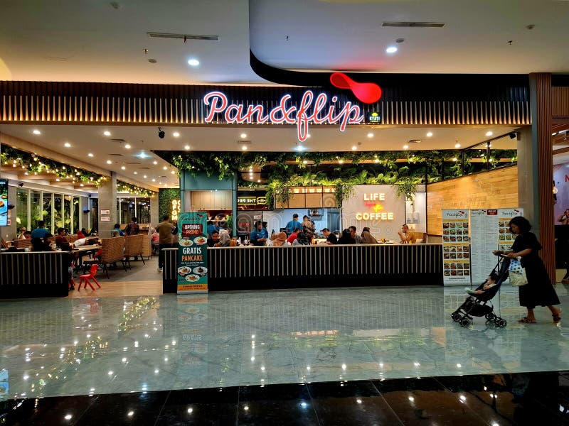 Front View of Pan and Flip Restaurant, Featuring Plant Elements in the ...