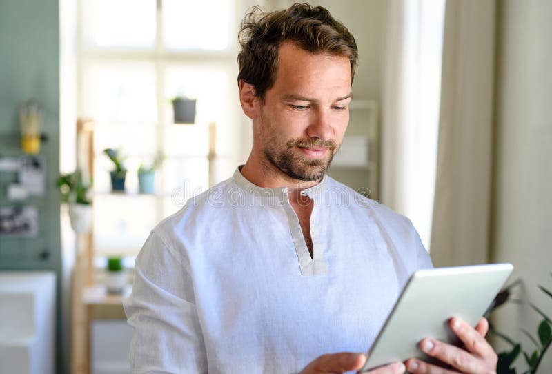 Front View Portrait of Man Using Tablet at Home. Stock Image - Image of ...