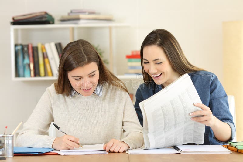 Two Students Comparing Newspaper News Stock Photo - Image of laughing ...