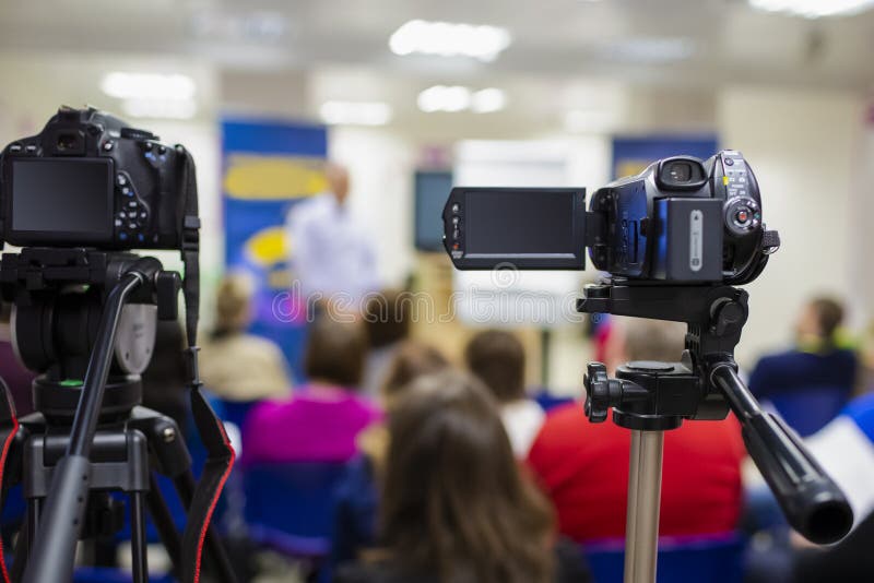 Front View of Professional Videocamera. Positioned Against Blurred ...