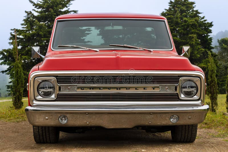 Front View of a Restored Old Red Chevrolet in a Green Field Editorial ...