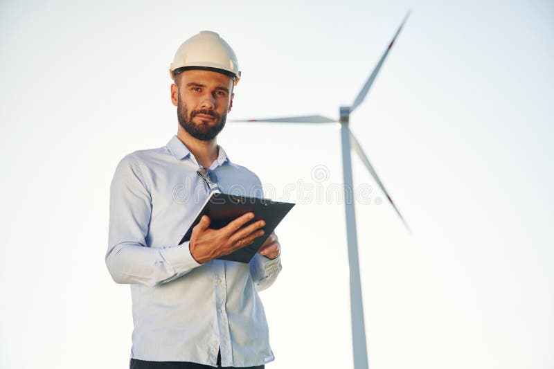 Handsome Service Engineer is Standing on the Field with Windmills Stock ...