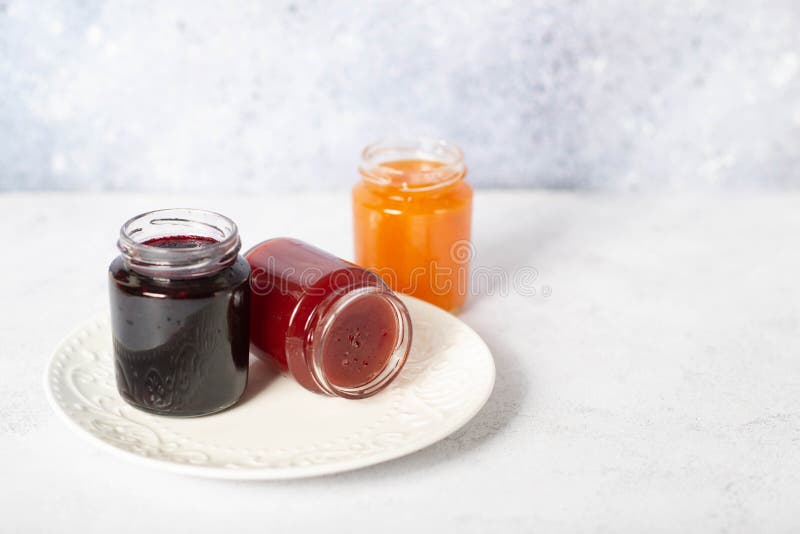 Front View of Set of Small Jam and Vegetable Jars in Different Colors ...