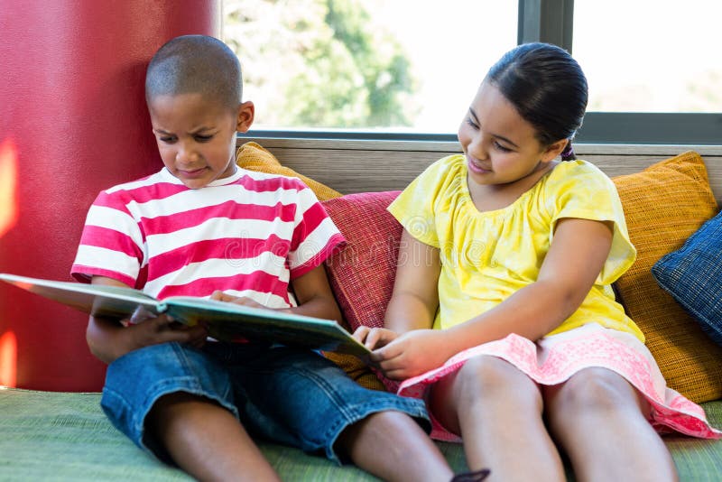 Front View of Siblings Reading Book at Home Stock Image - Image of ...