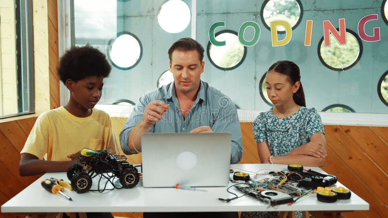 Teacher Looking at Laptop Screen while Explain Car Model System ...