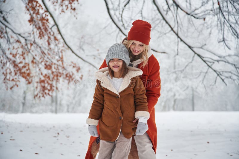 Front View, Standing. Mother and Her Daughter is on the Winter Meadow ...