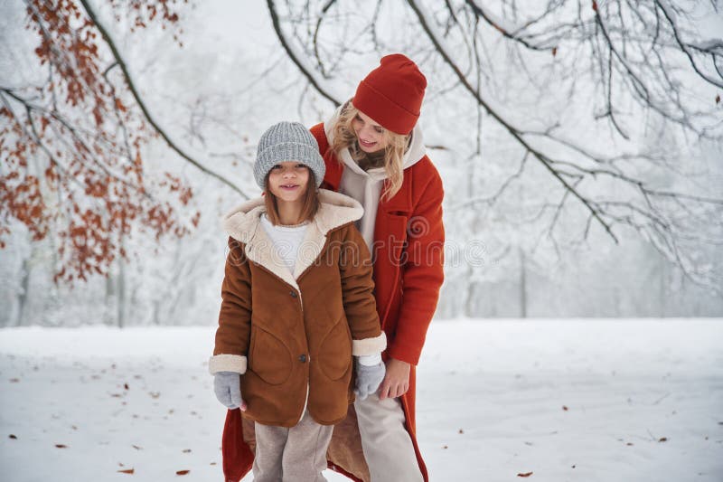 Front View, Standing. Mother and Her Daughter is on the Winter Meadow ...