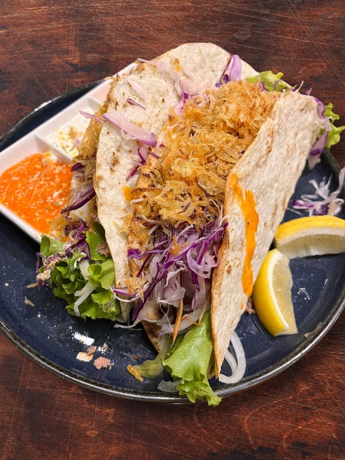 Front View of Tacos on Plates with Beef, Lettuce, Tomatoes, Cheese ...