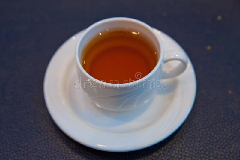 Front View . Tea Cup Over Blue Background . White Glass Cup Isolated on ...
