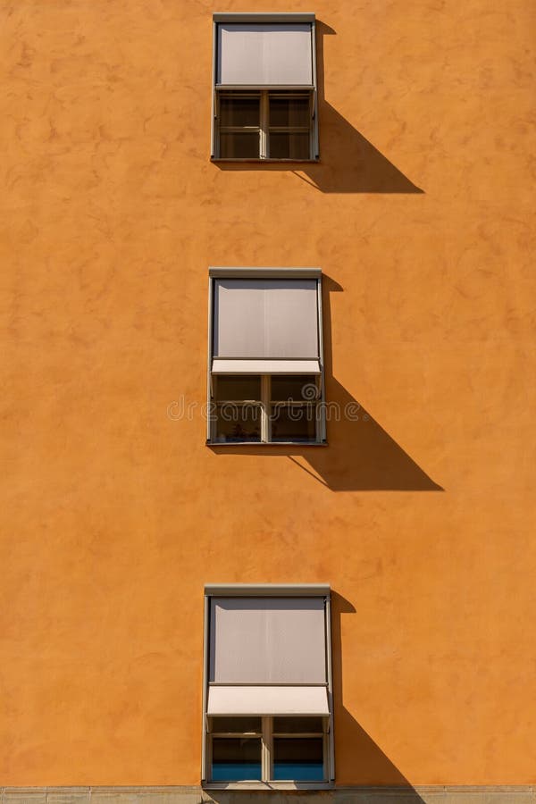 Front View of Three Symmetrical Windows with Sun Blinds on a Stone City ...