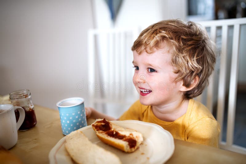 A Front View of a Toddler Boy Eating at Home. Stock Image - Image of ...