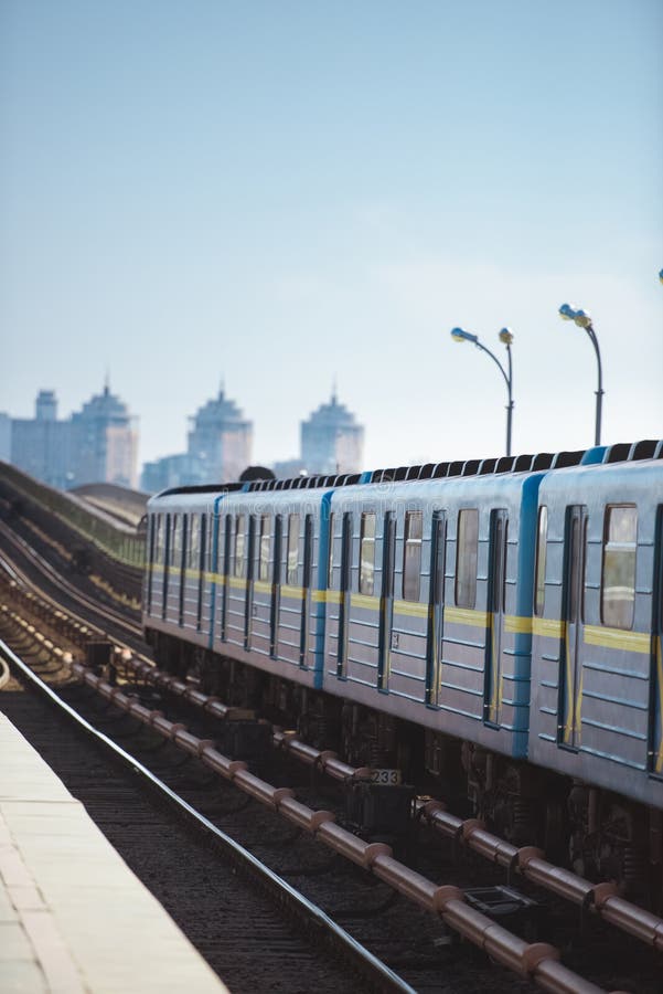Front View of Train at Outdoor Subway Station with Buildings Stock ...