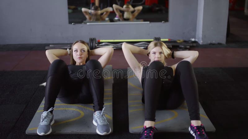Front View of Two Blonde Women Does Sit-up Exercise at Gym Stock Video ...