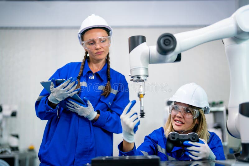 Front View of Two Professional Technician or Engineer Women Sit and ...