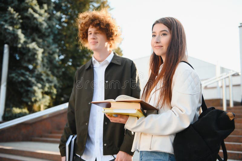 Front View of Two Students Walking and Talking in an University Campus ...