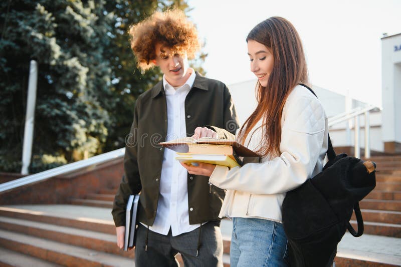 Front View of Two Students Walking and Talking in an University Campus ...