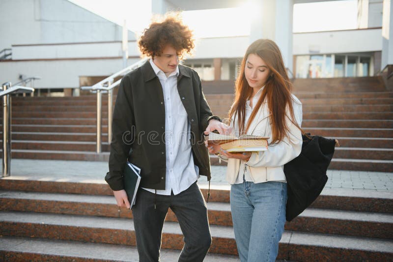 Front View of Two Students Walking and Talking in an University Campus ...