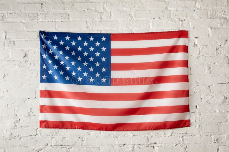 Front View of United States of America Flag on White Brick Wall Stock ...