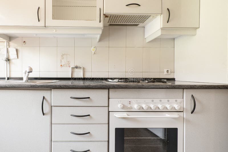 Front View of a Vintage White Kitchen with Gray Countertops and ...