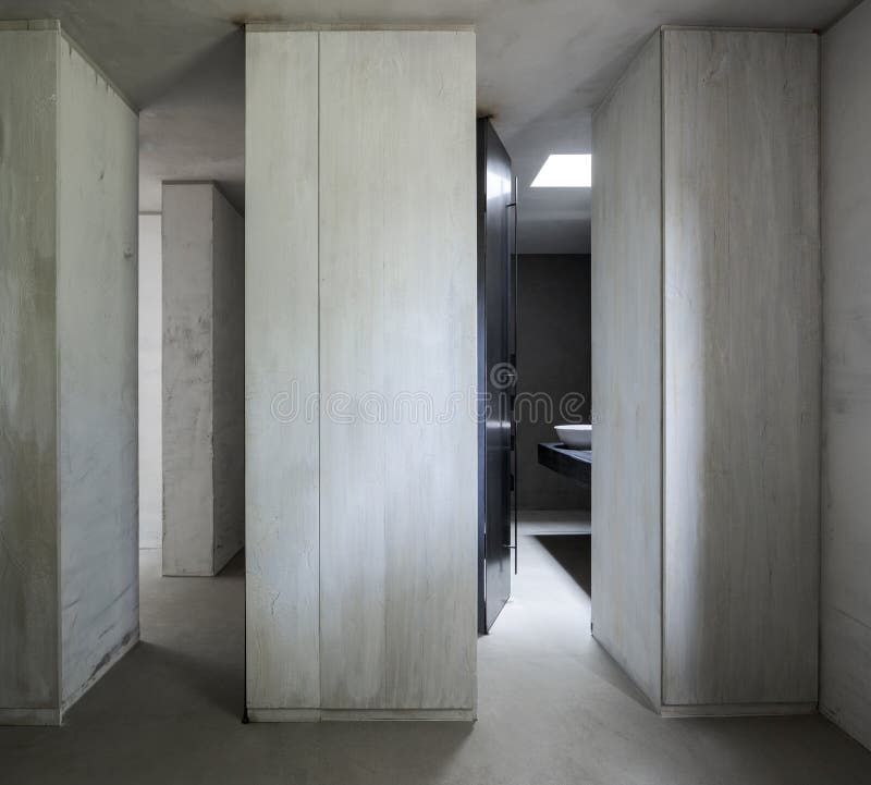 Front View of a Wall with a Hallway and an Open Door To a Modern ...