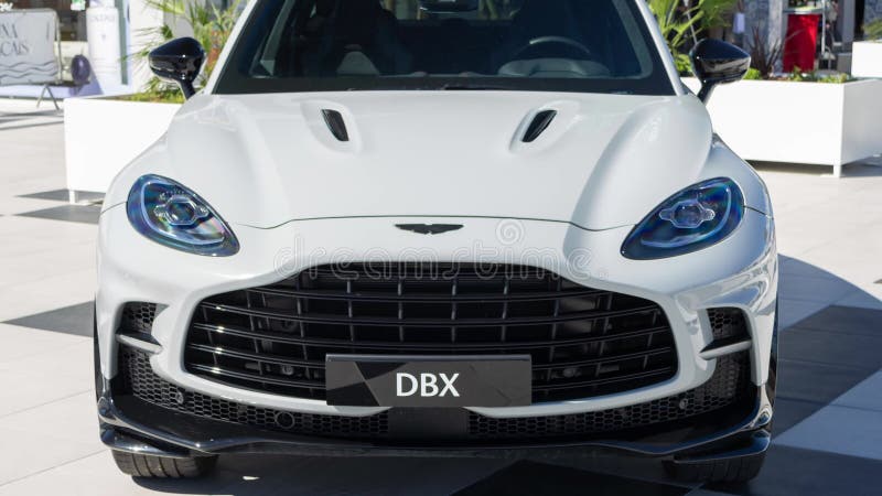 Front View of a White Aston Martin DBX SUV Parked on Checkered Pattern ...