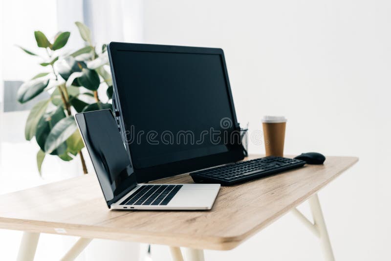 Front View of Workplace with Laptop, Computer, Paper Cup of Coffee on ...