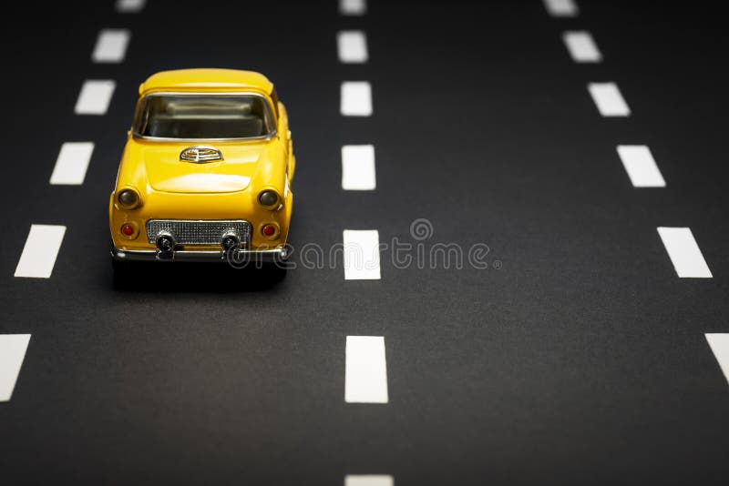 Front View of a Yellow Toy Car on an Asphalt Road Stock Photo - Image ...