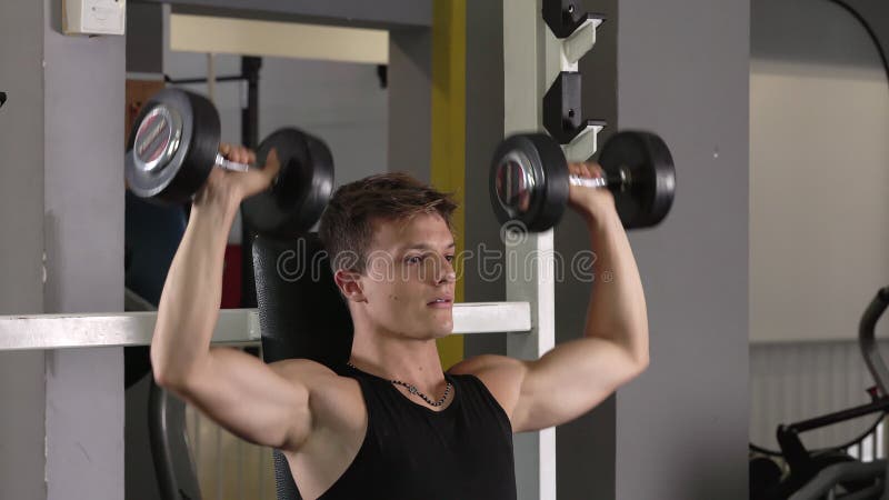 Front View of a Young Caucasian Bodybuilder Training Arm Muscles by ...