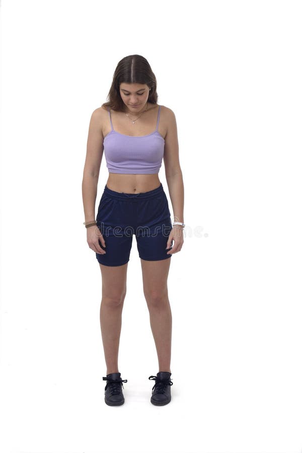 Front View of a Young Girl Standing and Looking the Floor Stock Photo ...