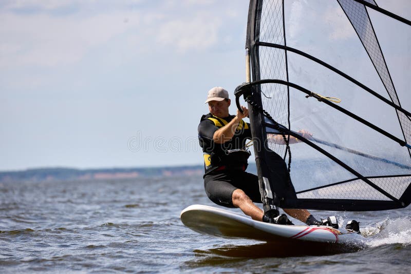 Young Man Surfing the Wind in Splashes of Water Stock Image - Image of ...