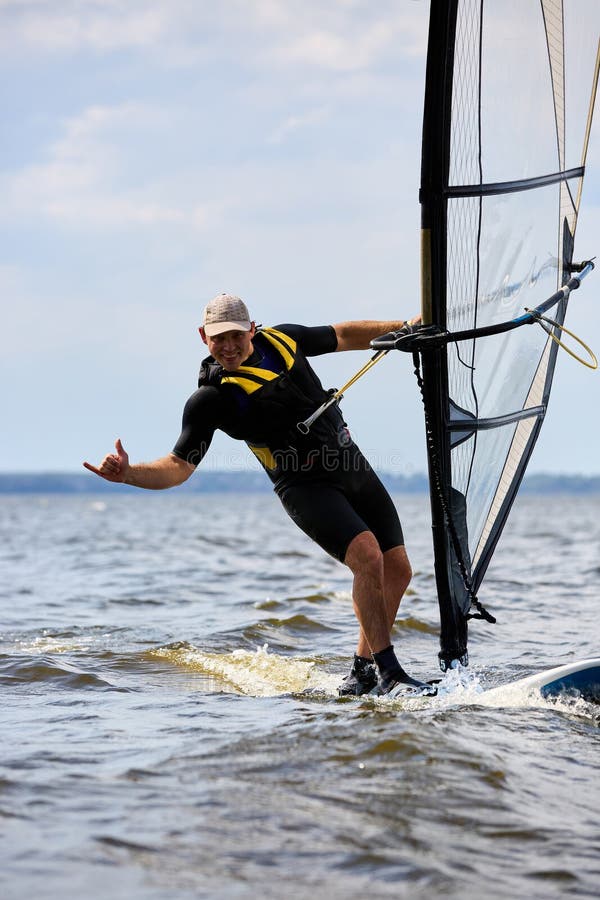 Young Man Surfing the Wind in Splashes of Water Stock Image - Image of ...