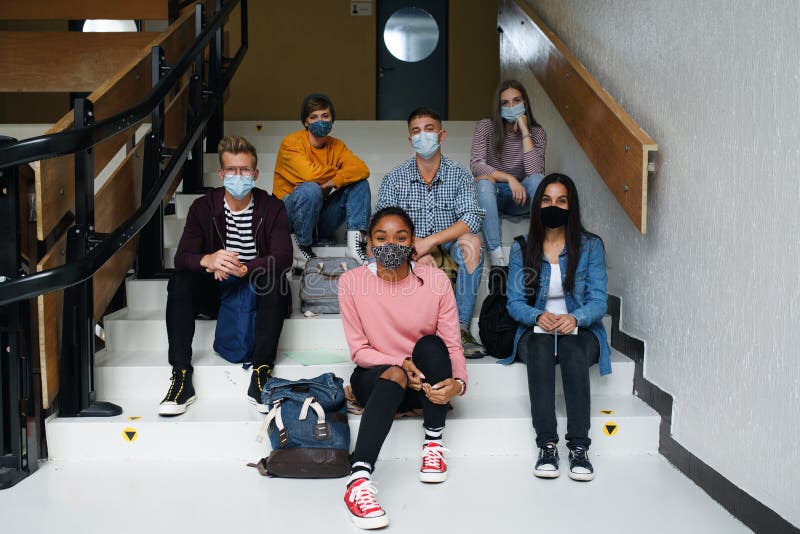 Front View of Young Students with Face Masks Back at College or ...