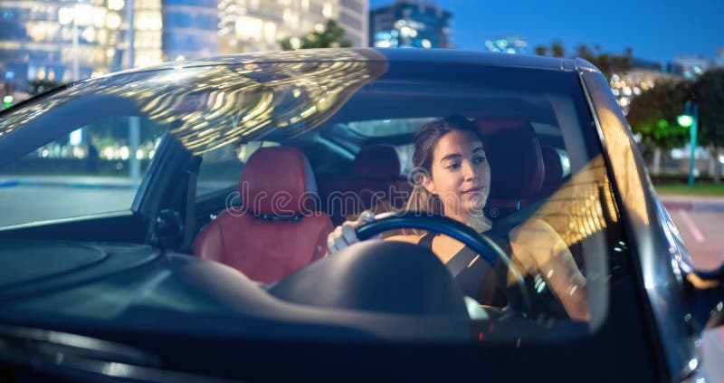 Front View of Young Woman Driving Car at Night. Stock Image - Image of ...