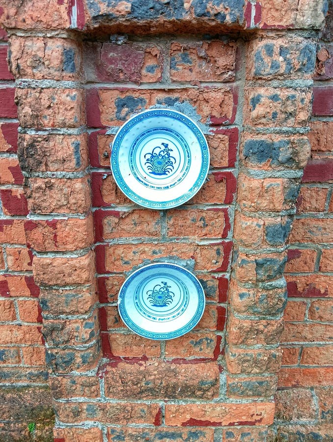 The Front Wall of the House with an Ancient Motif Decorated with Plates ...