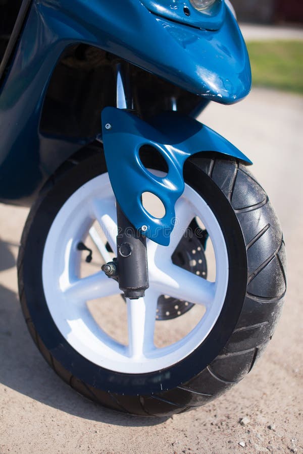 Front Wheel of Blue Modern Scooter on the Gravel Road Stock Photo ...