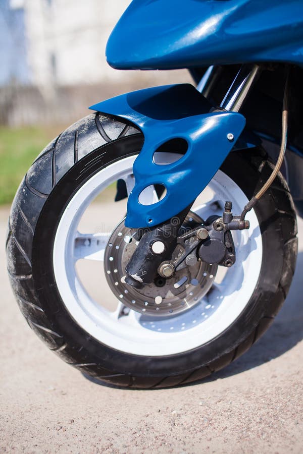Front Wheel of Blue Modern Scooter on the Gravel Road Stock Image ...