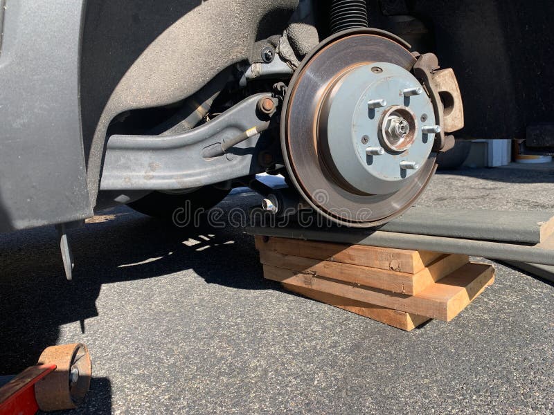 Front Wheel of Car Up on Wooden Blocks at Home Tire Rotation Stock ...