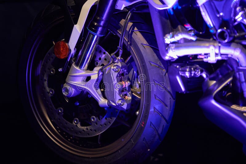 The Front Wheel of a Modern Motorcycle with Blue Lighting. Studio ...