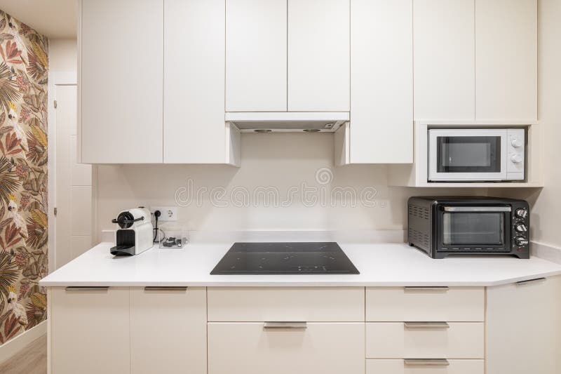Frontal Shot of a White Kitchen Unit with Functional Appliances and a ...