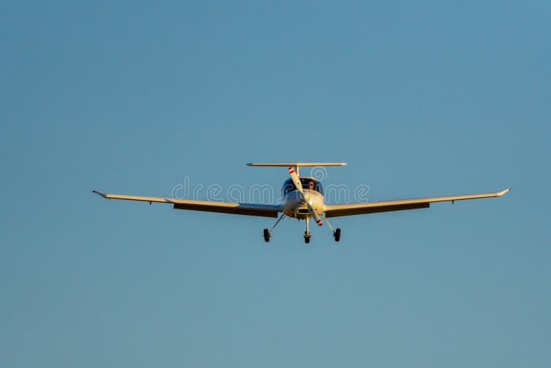Frontal View of Airplane Approaching the Runway at Sunset Stock Photo ...