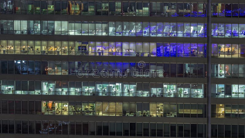Frontal View of Night Facade of Building with a Lot of Windows with ...
