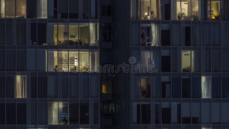 Frontal View of Night Facade of Building with a Lot of Windows with ...