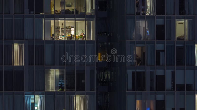 Frontal View of Night Facade of Building with a Lot of Windows with ...