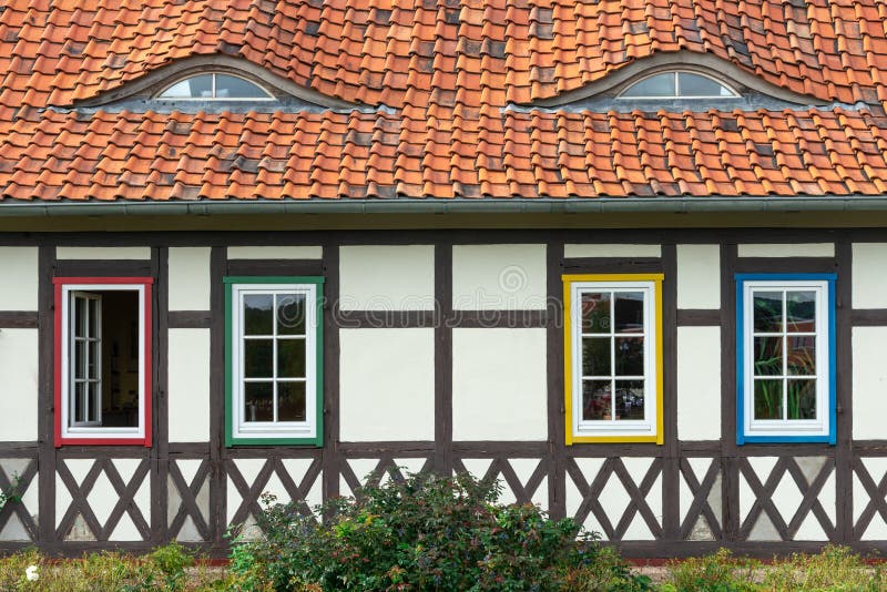 Frontal View of a Traditional Half-timbered House with Colorful Windows ...