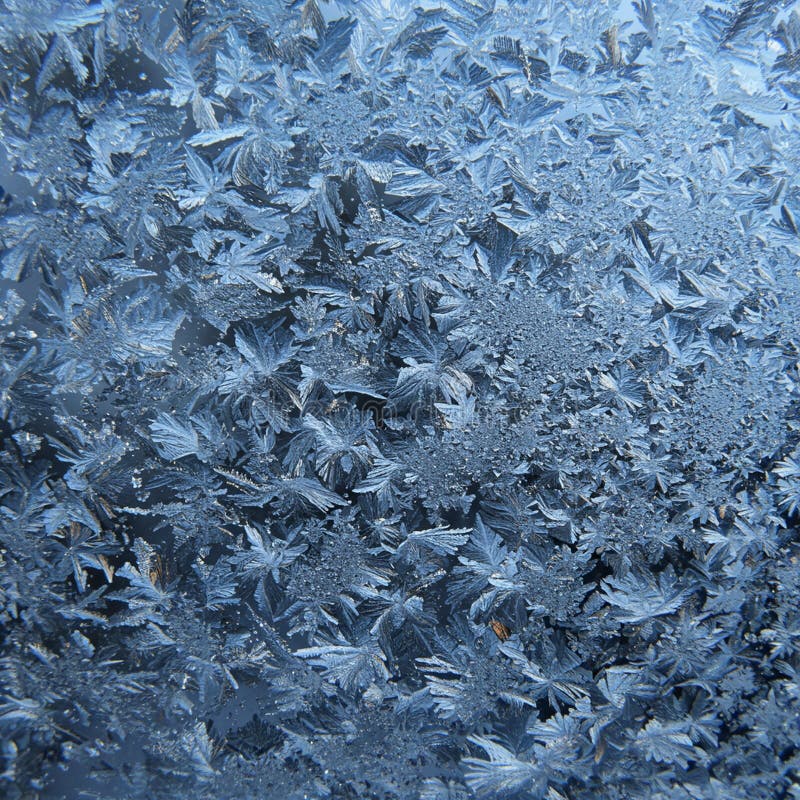 Frost Crystals Form Intricate Patterns on a Glass Surface. the Ice ...