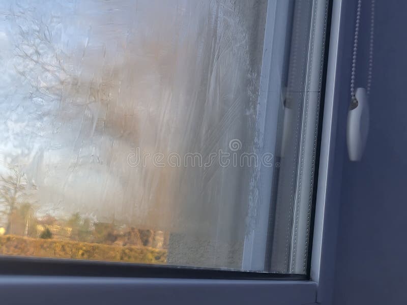 Frosted Window Pane with a View of a Peaceful Landscape Outside ...